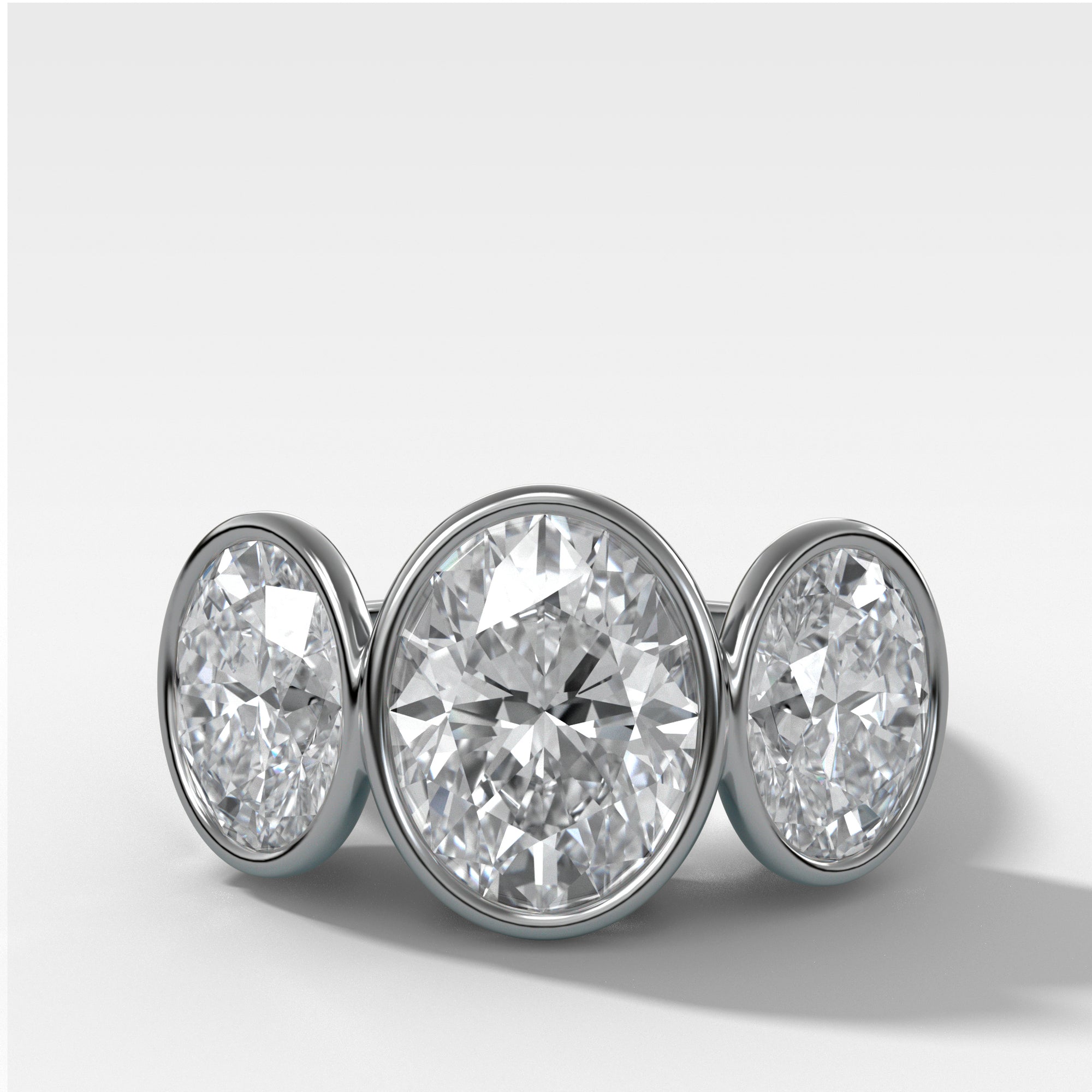 Penumbra Bezel Triad Engagement Ring With Oval Cut Diamonds | GoodStone