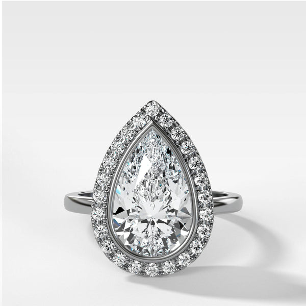 Bezel Set Halo Engagement Ring With Pear Cut Diamond | GoodStone